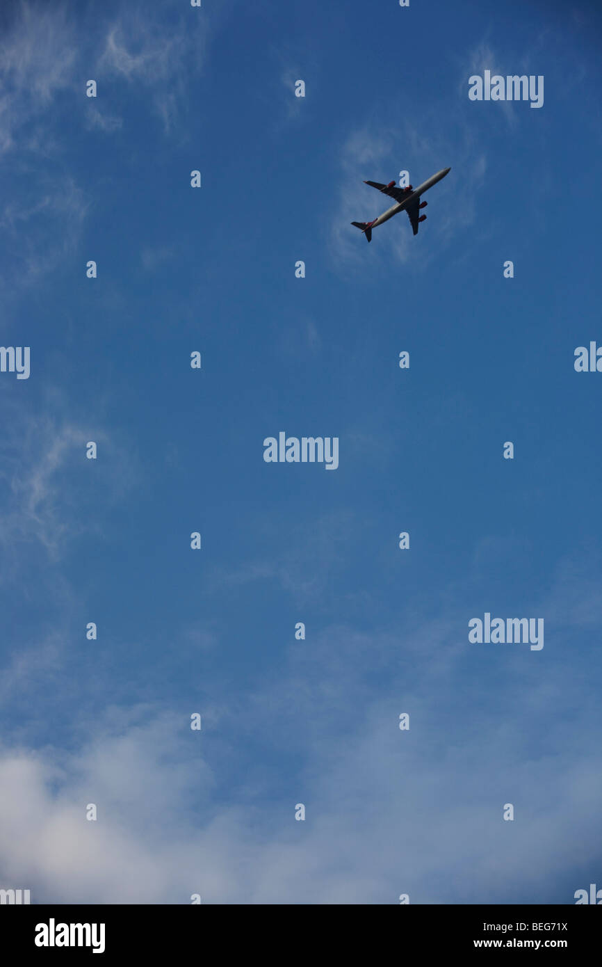 In the top-right corner of the image, an airliner passes overhead in ...