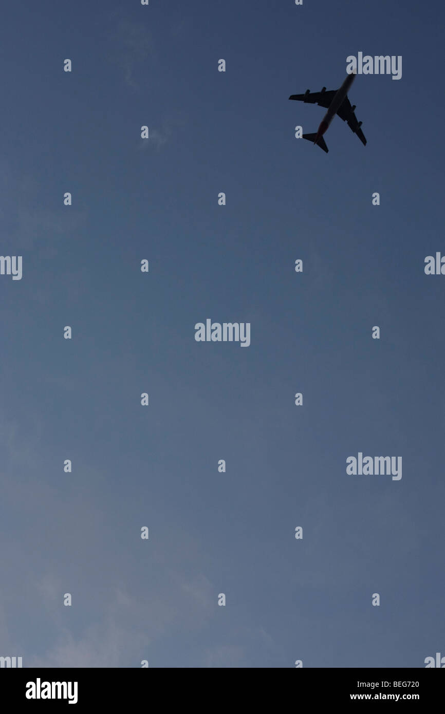 In the top-right corner of the image, an airliner passes overhead in ...