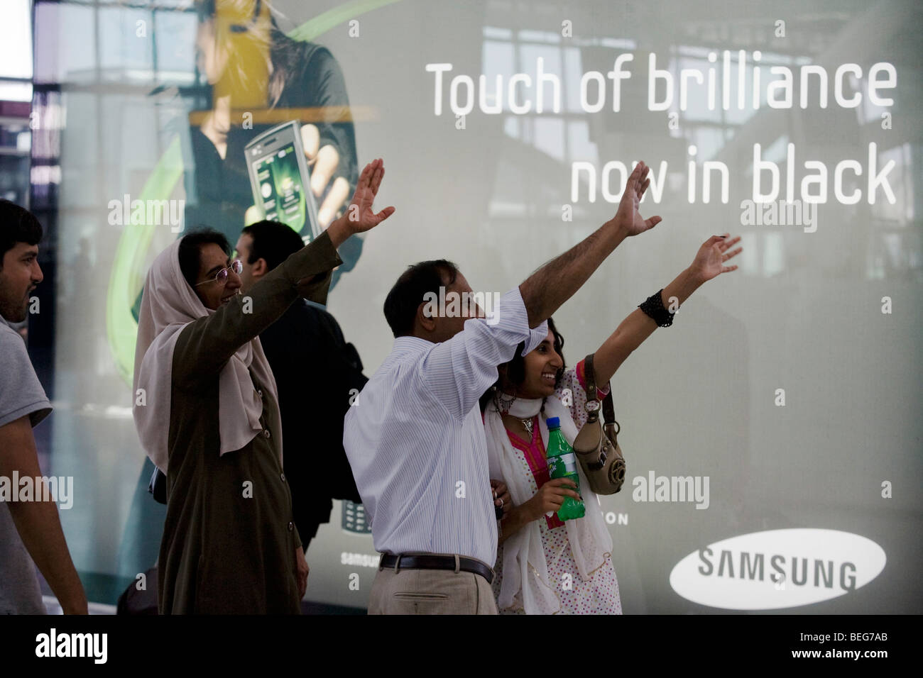 An Asian family wave farewell to loved-ones departing on a flight from ...