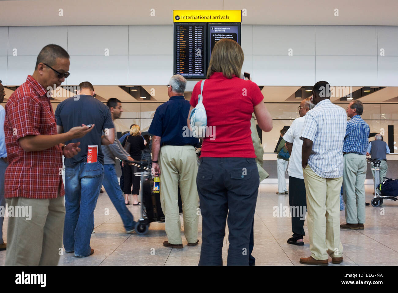 Family members and drivers await appearing passengers in international ...