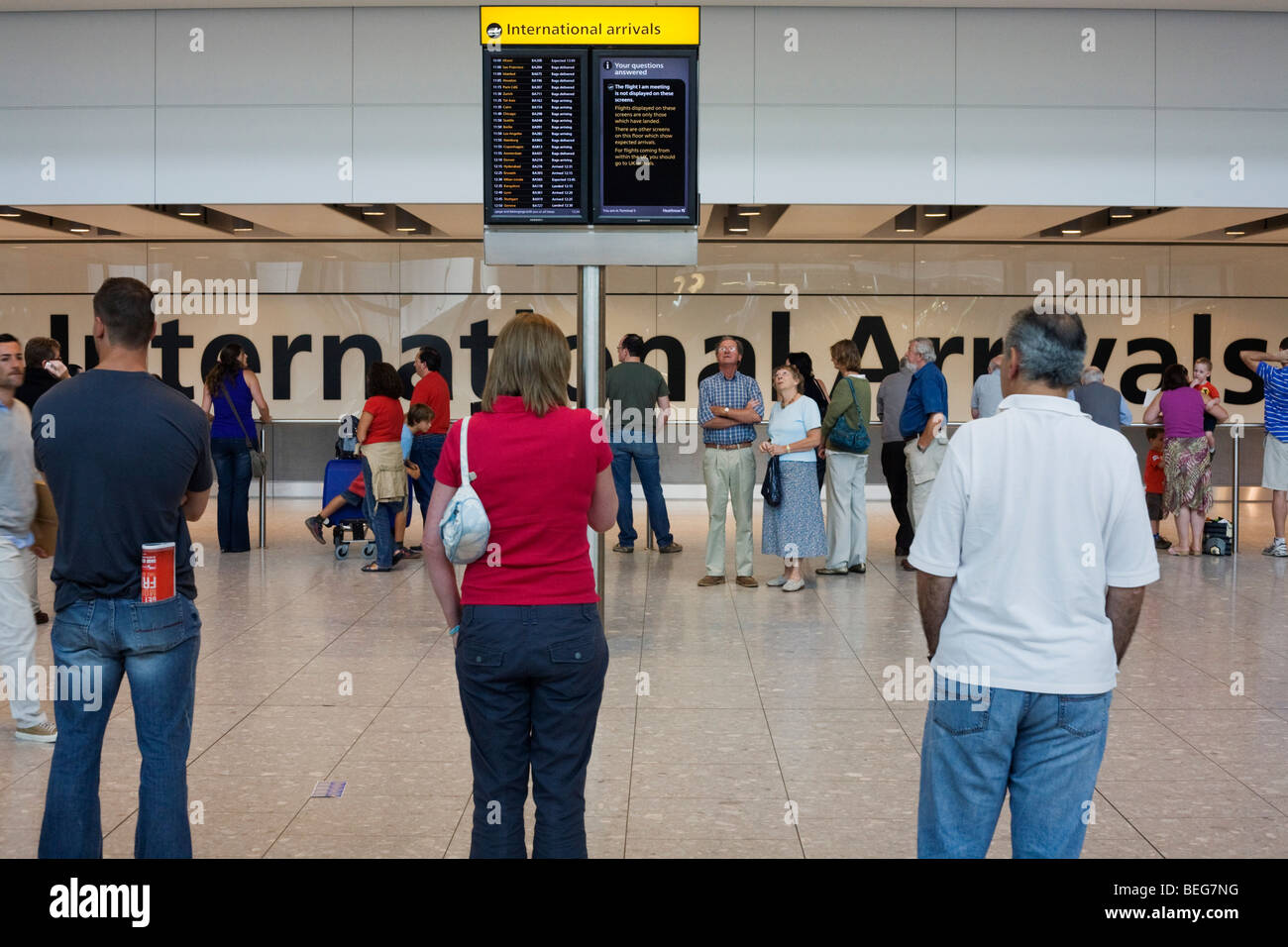 Family members and drivers await appearing passengers in international ...