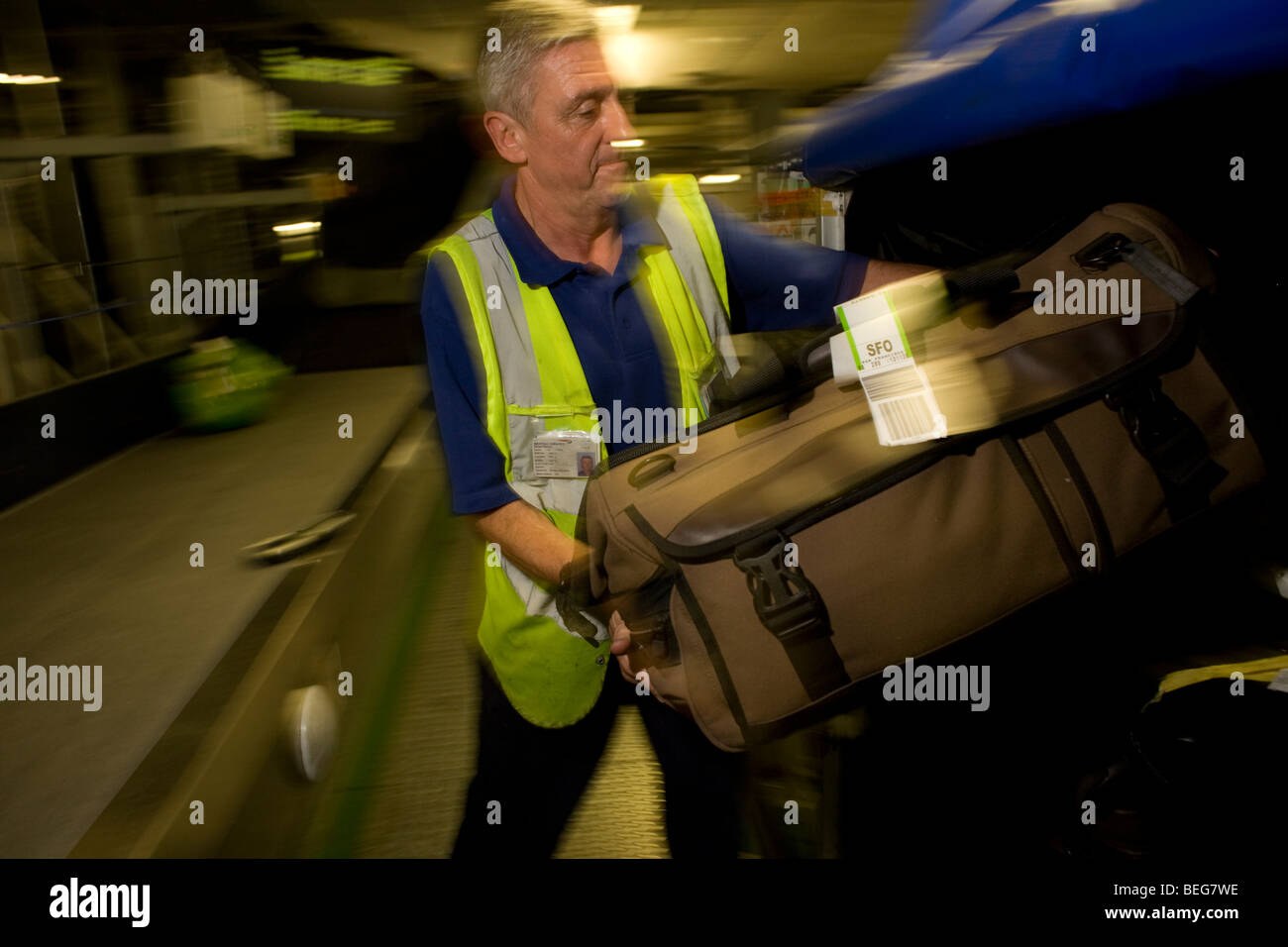 A British Airways baggage loads passengers' possessions into an airline ...