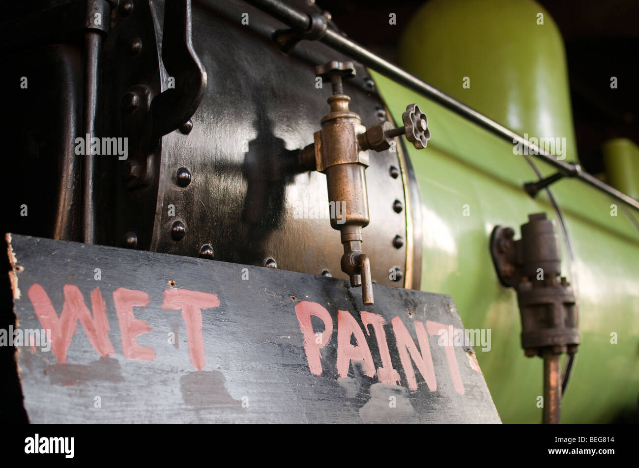 A "wet paint" sign on a steam engine Stock Photo - Alamy