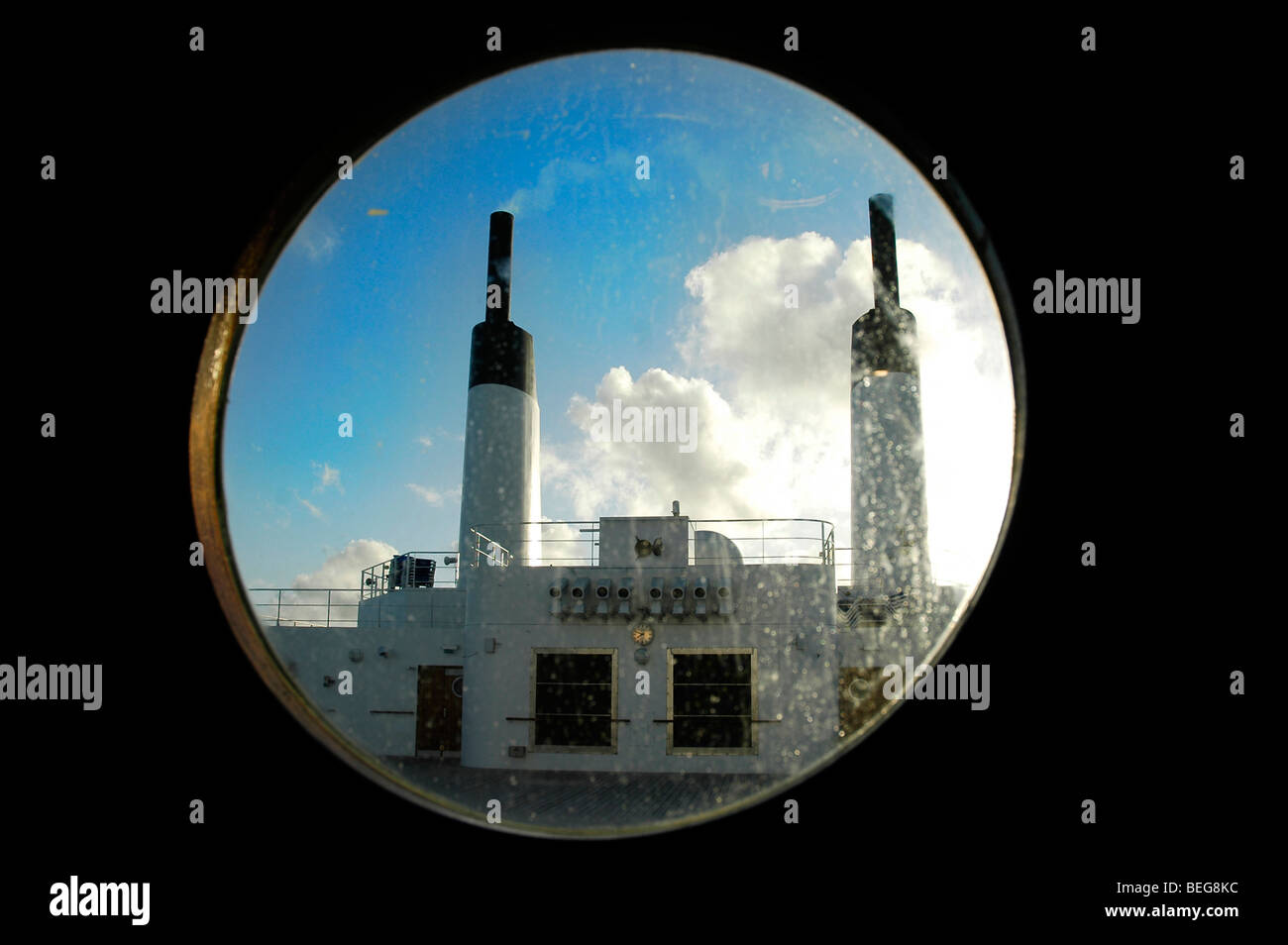 Queen Mary 2's rear twin funnels seen through port hole Stock Photo - Alamy
