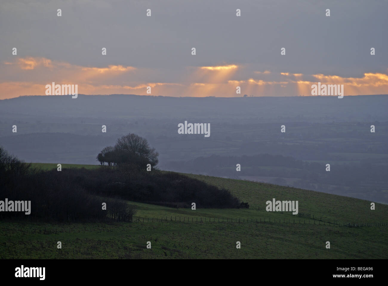 winter sunset from fontmell down with shafts of golden light over ...