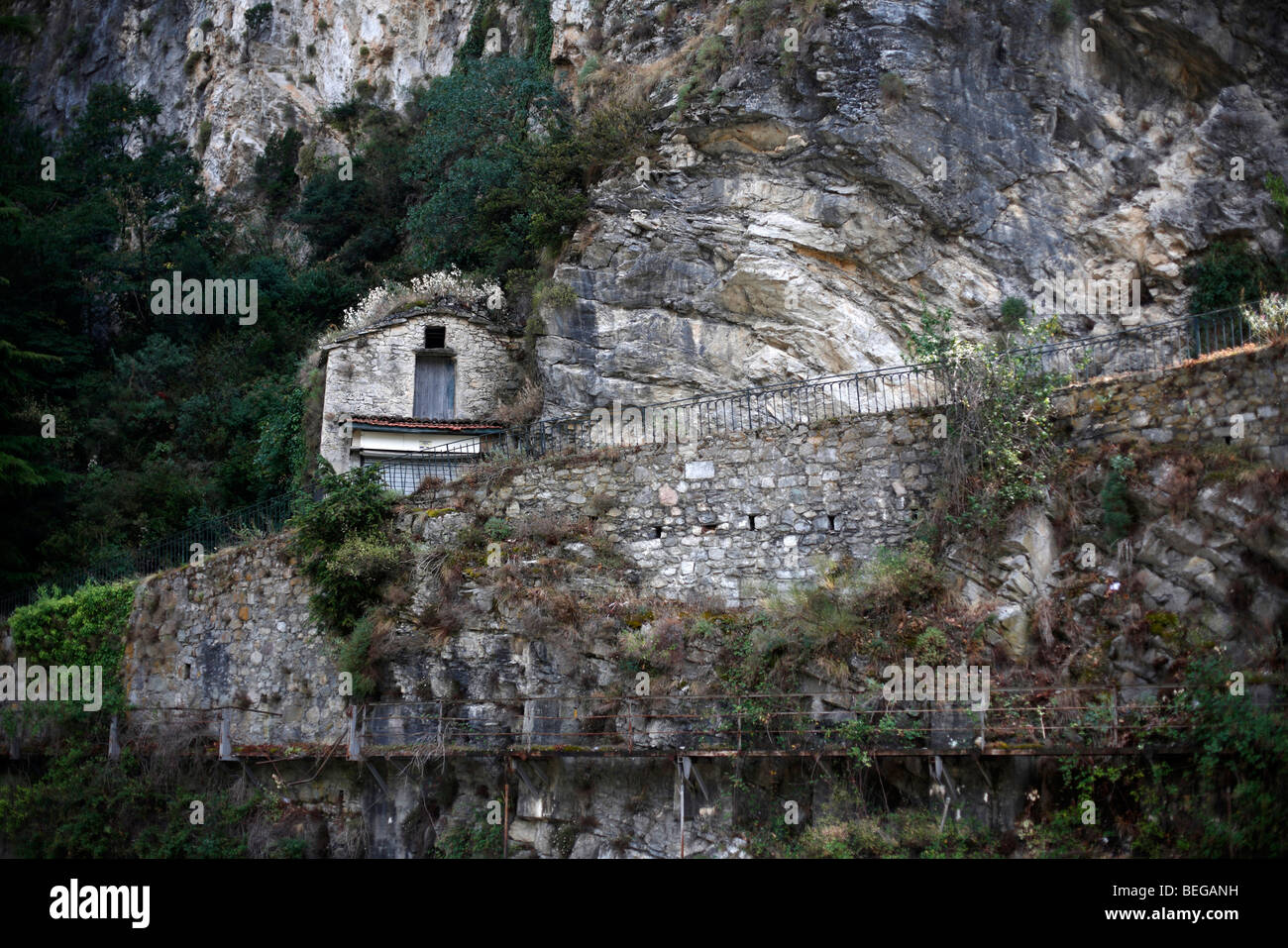 A small building built into the cliff face above the town of Breil-sur ...