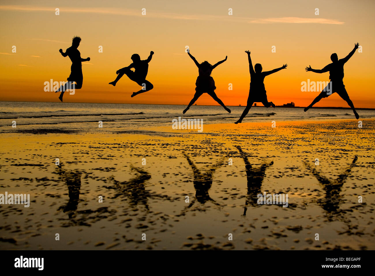 Friends enjoying a good time at the beach Stock Photo - Alamy
