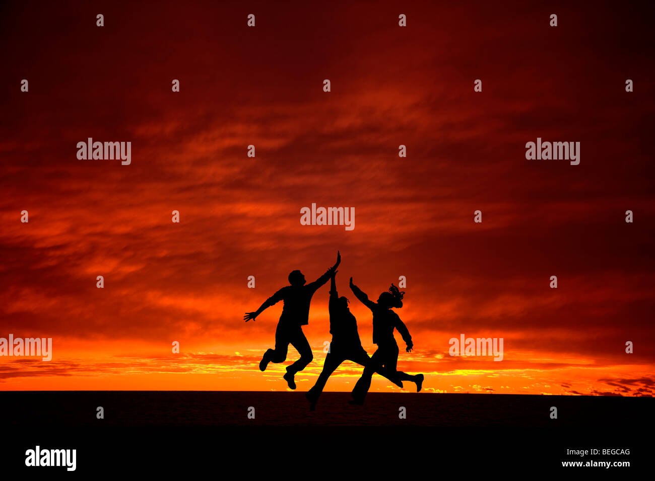 Friends having fun outdoors during a gorgeous sunset or sunrise Stock ...