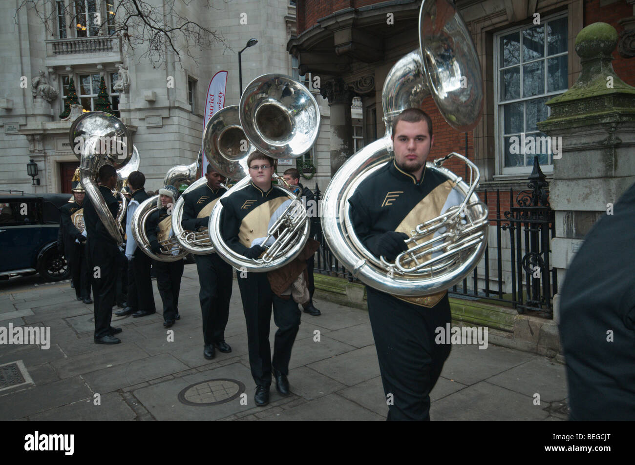A line of sousaphone players from a US HIgh School Marching band on a ...
