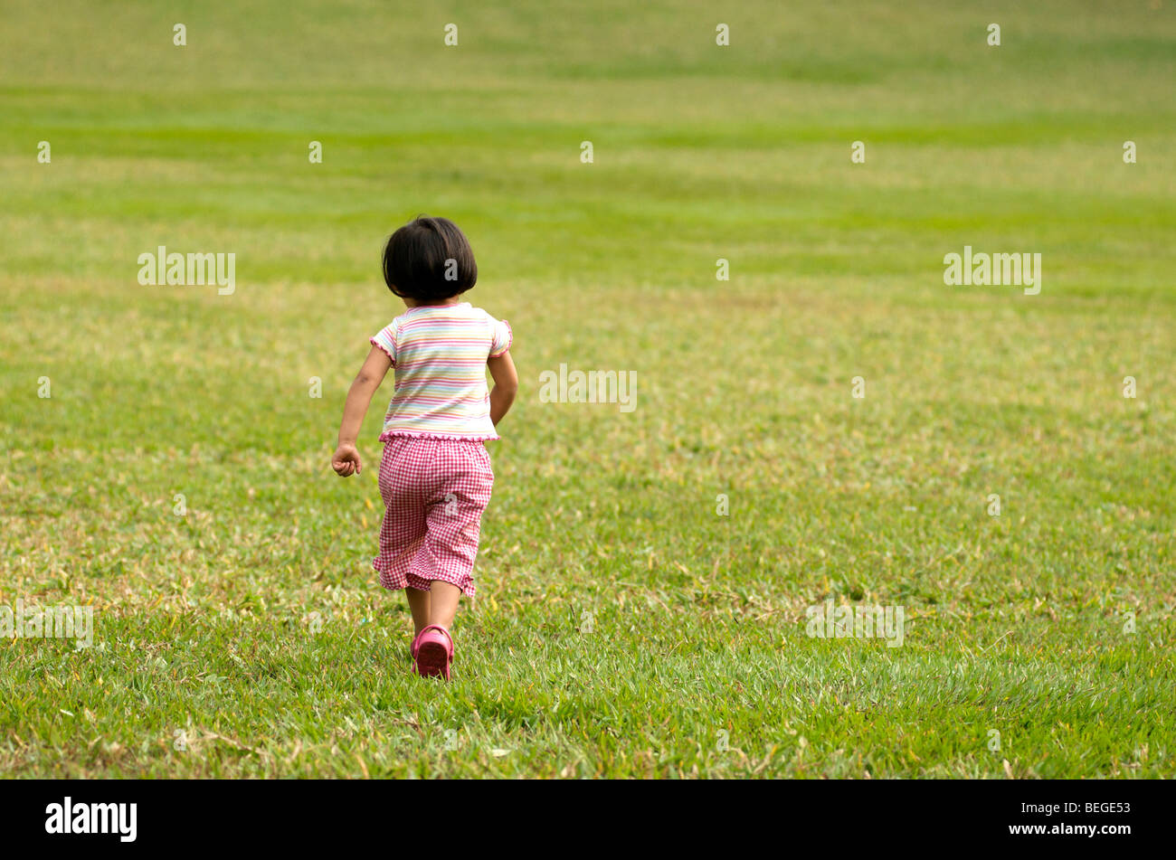 A child walking in a park Stock Photo - Alamy