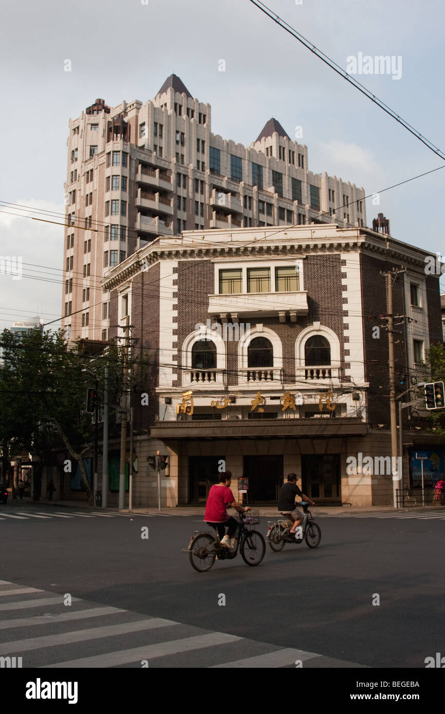 Two mopeds speed past the Lyceum Theatre on Changle Road, Shanghai ...