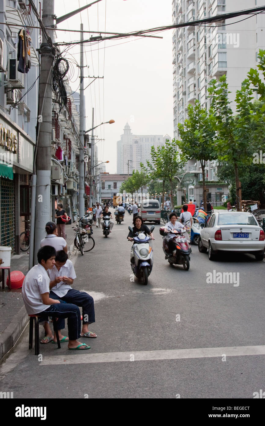 People sitting outside on the street in Shanghai China Stock Photo - Alamy