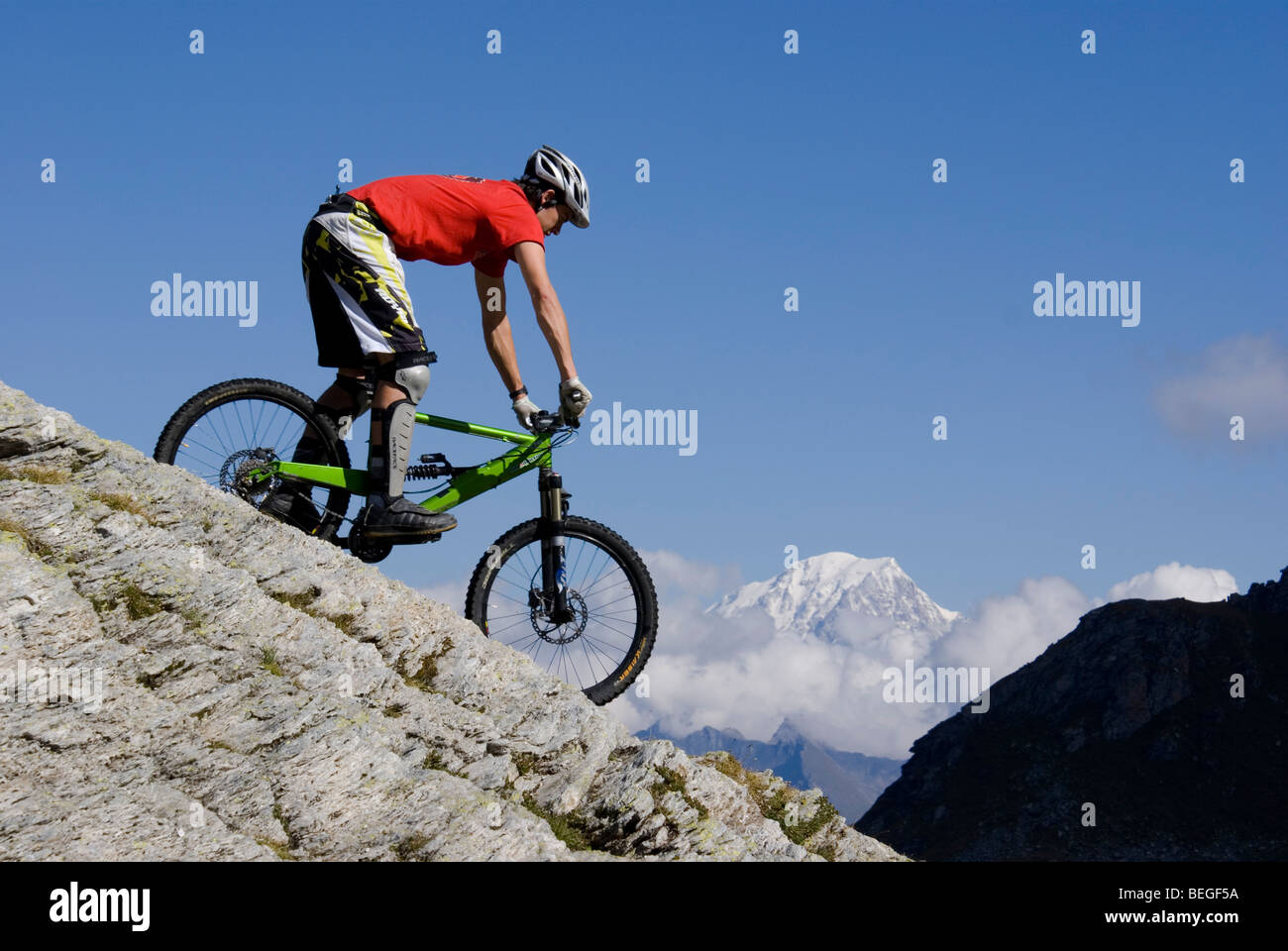 A mountain bikers rides down a rocky slope in Les Arcs in the French ...