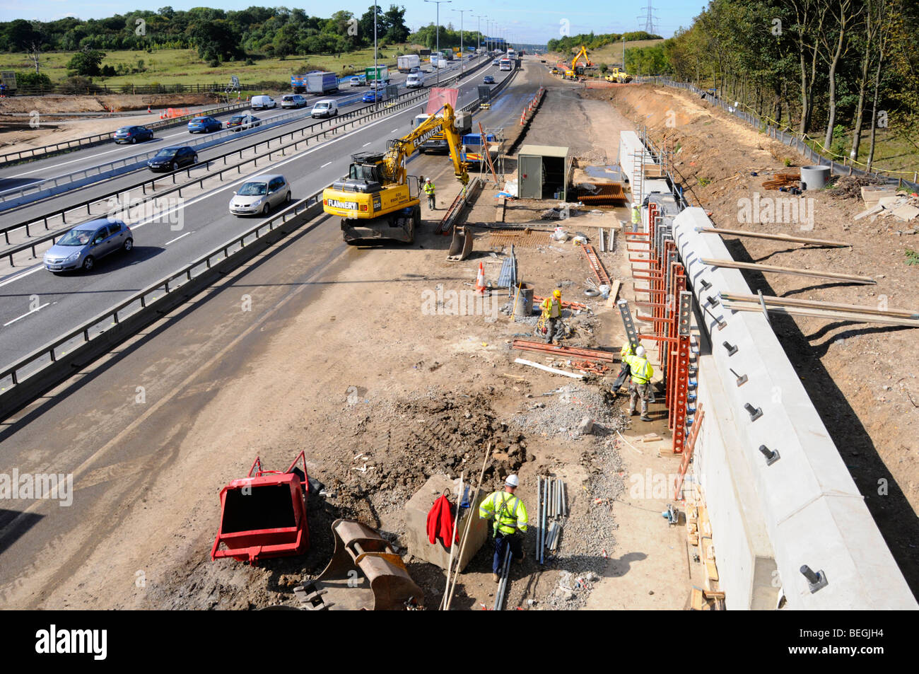 M25 road widening project with contra flow in operation men working on ...
