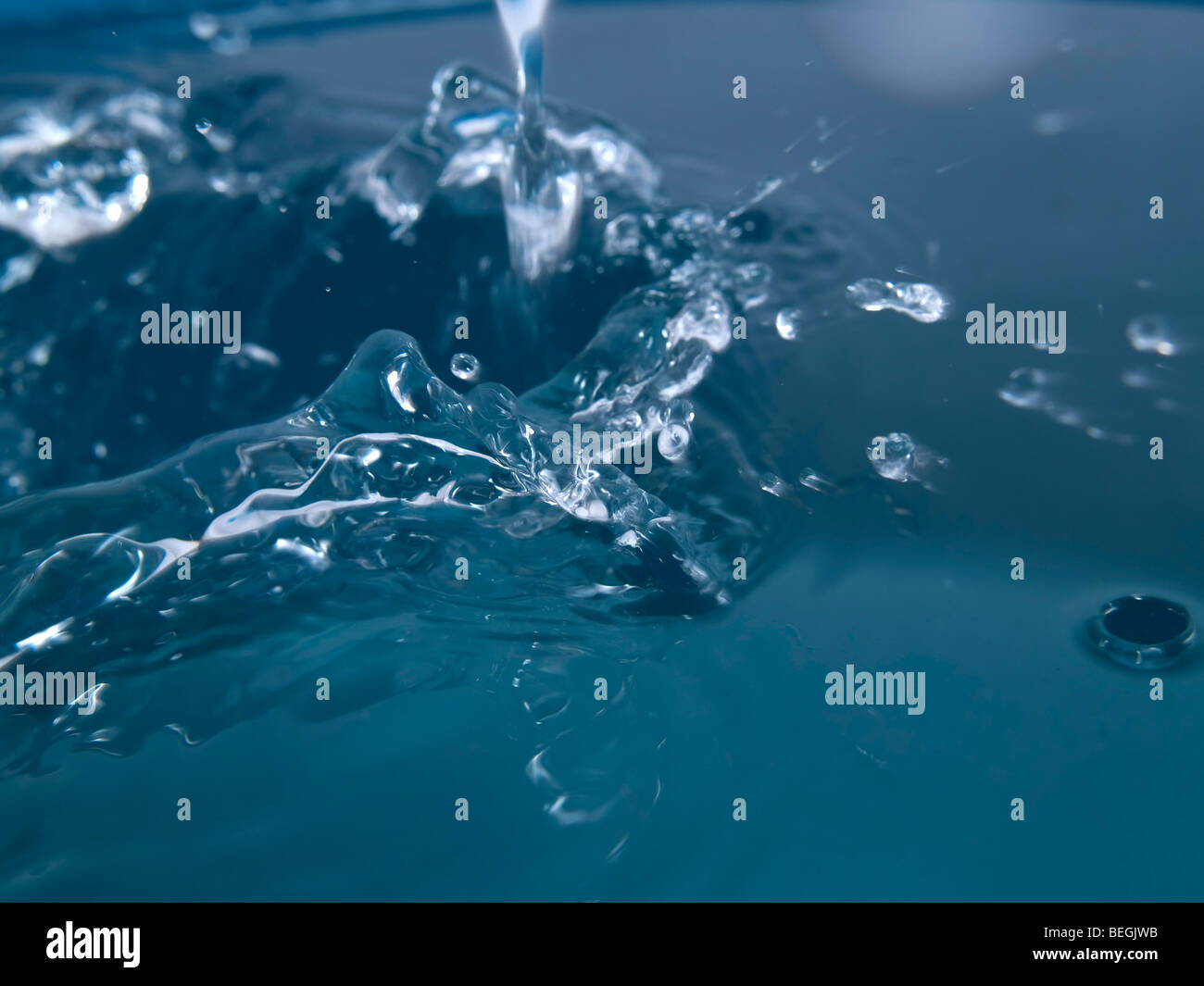 Splash on blue water surface macro horizontal Stock Photo - Alamy