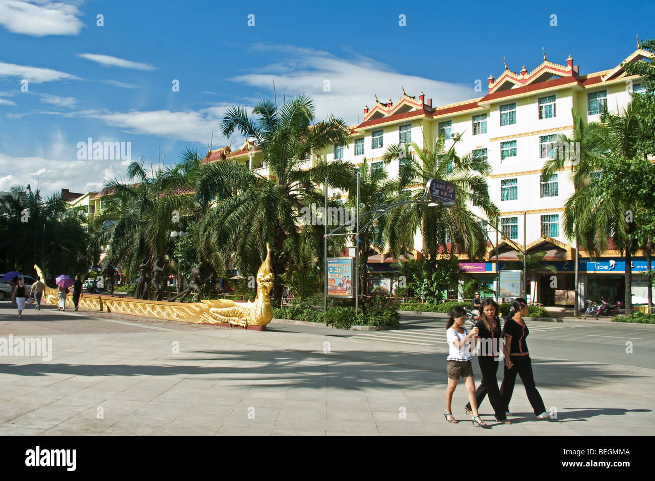 Modern and tribal girls walk down Jinghong City streets in Yunnan ...