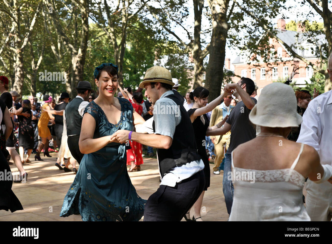 enthusiastic dancers in twenties attire fill the al fresco dance floor ...