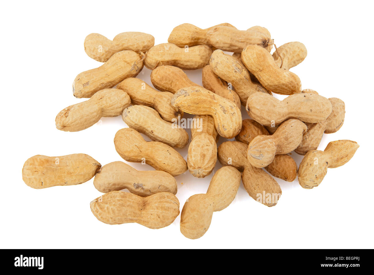 many burned peanuts isolated over white background Stock Photo - Alamy