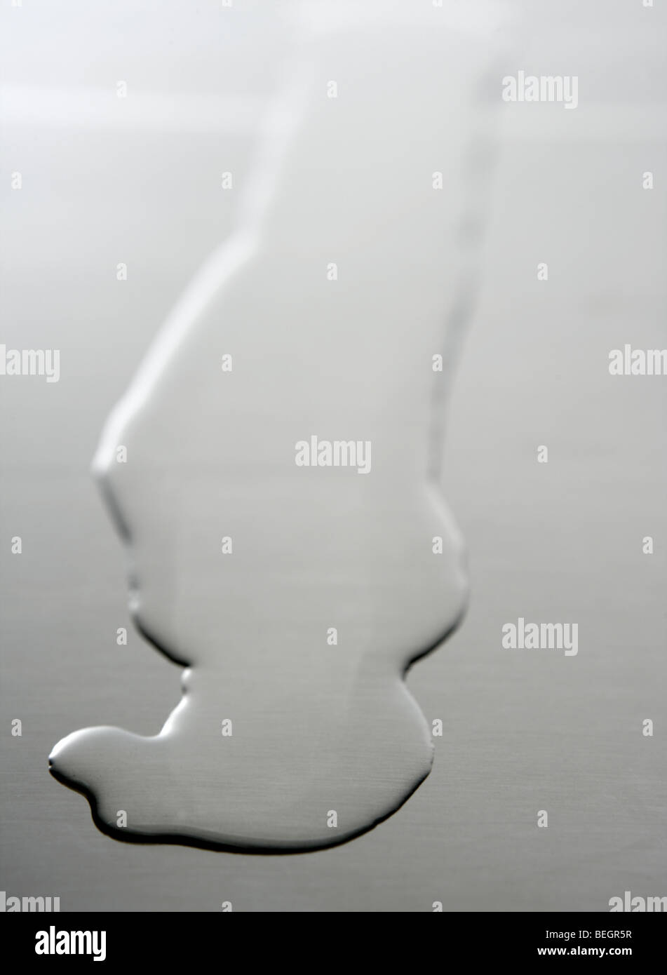 Liquid,transparent oil shape on a stainless steel metal surface Stock ...