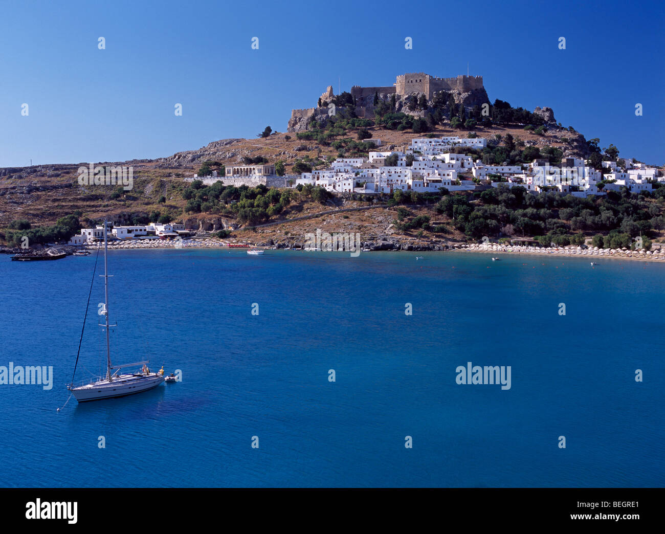 Lindos Bay, with Lindos village and acropolis, Rhodes, Greece Stock ...