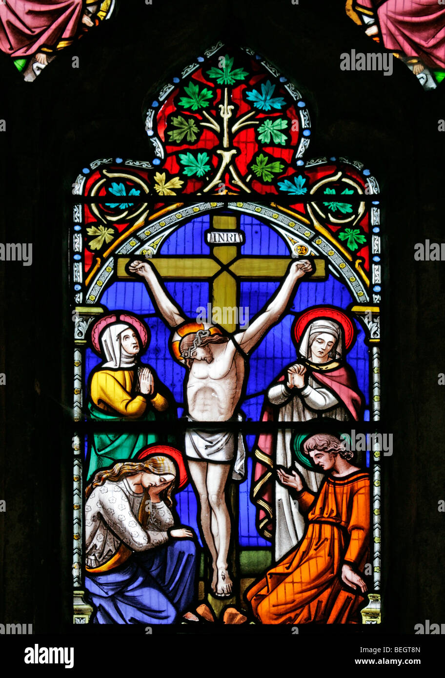 A stained glass window by William Warrington depicting the crucifixion ...
