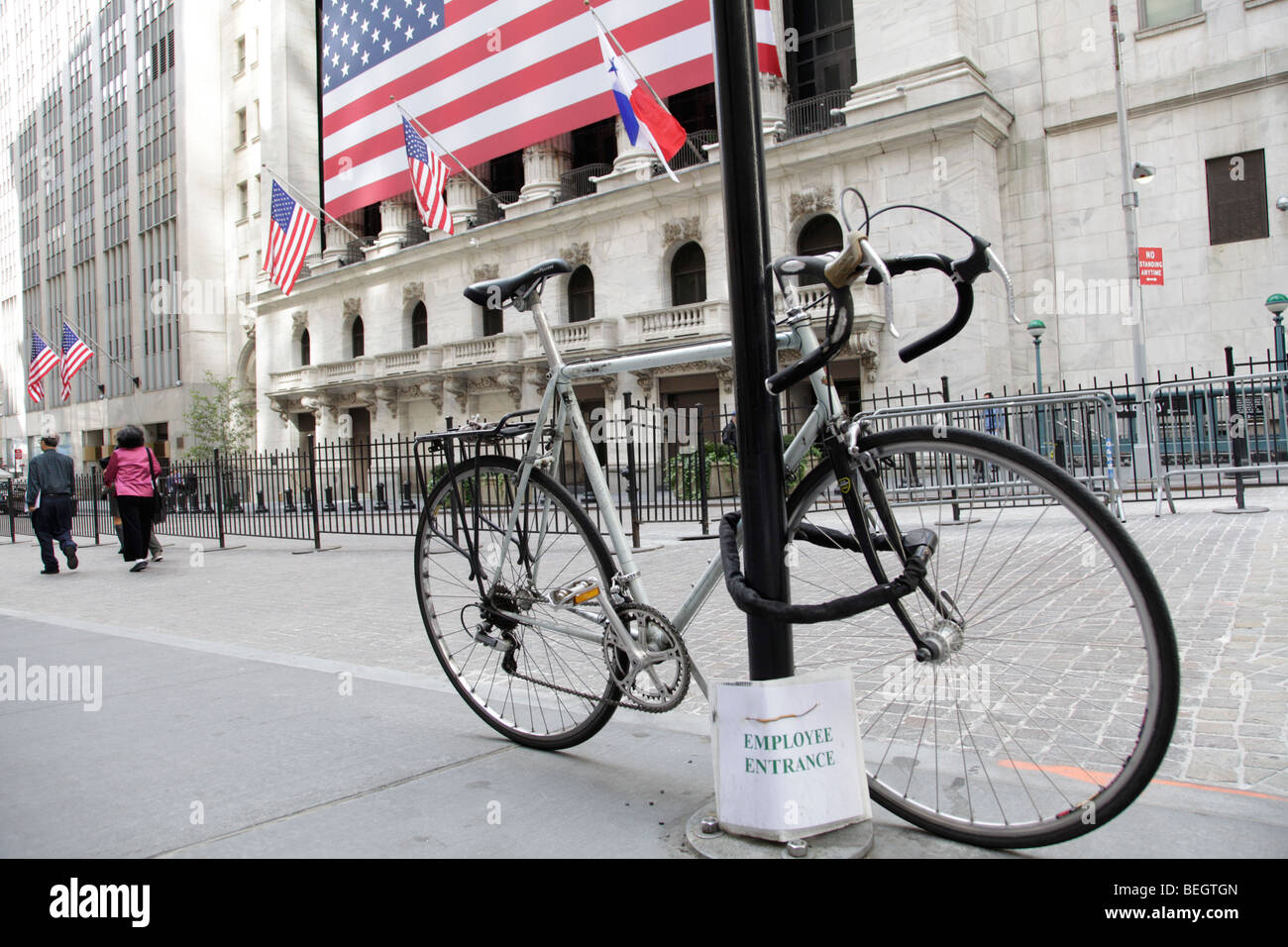 A bike chained to a lamp post outside the New York Stock Exchange on ...