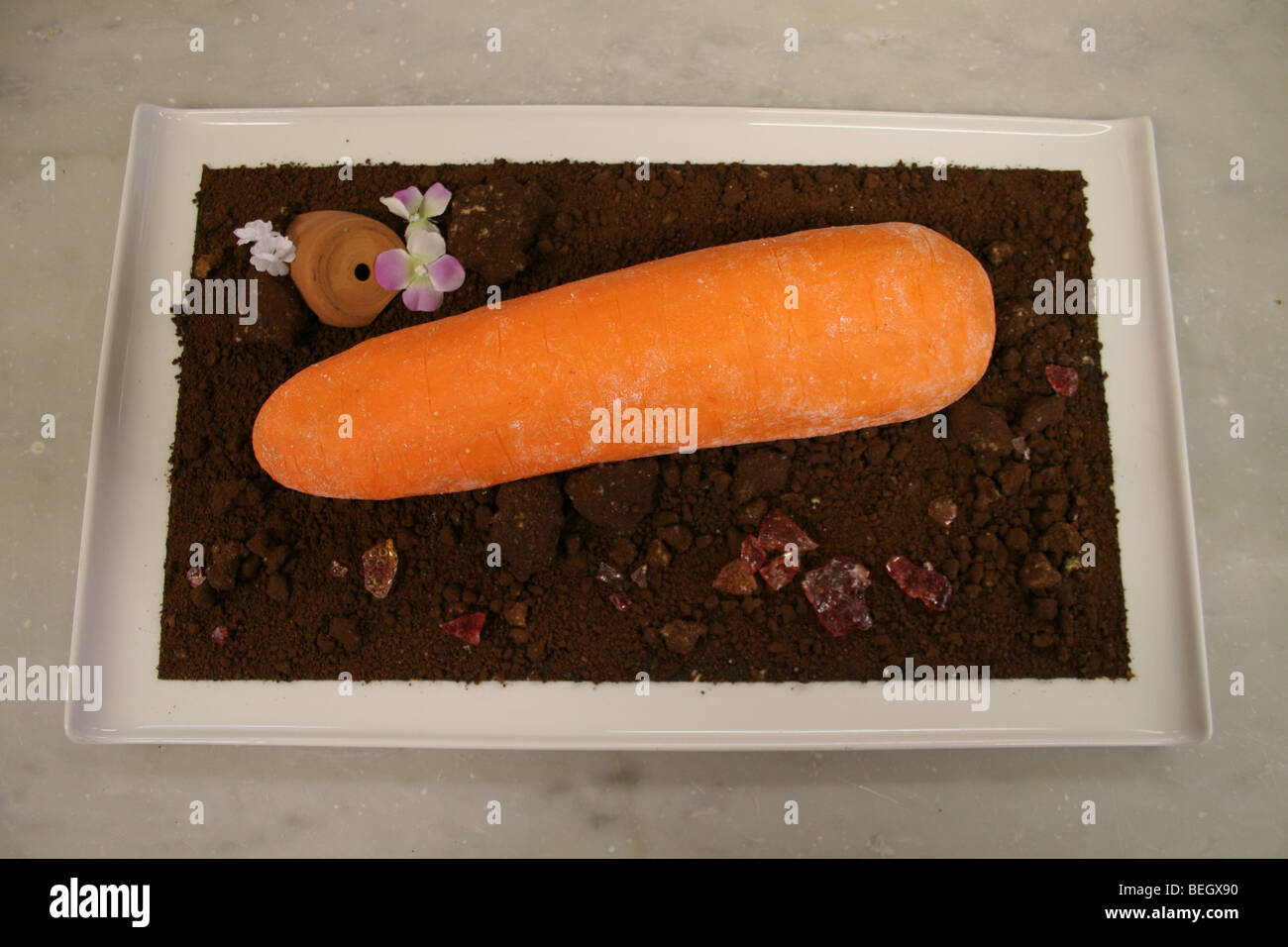 Carrot cake shaped as a carrot at a food fair Stock Photo - Alamy