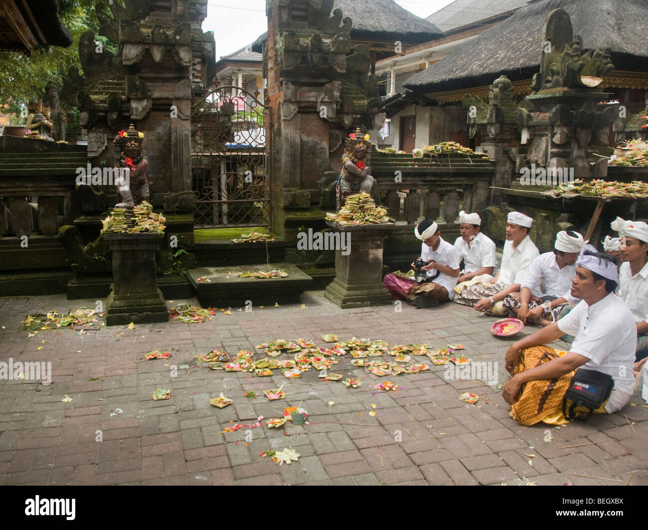praying, during a traditional funeral and cremation ceremony in Ubud in ...