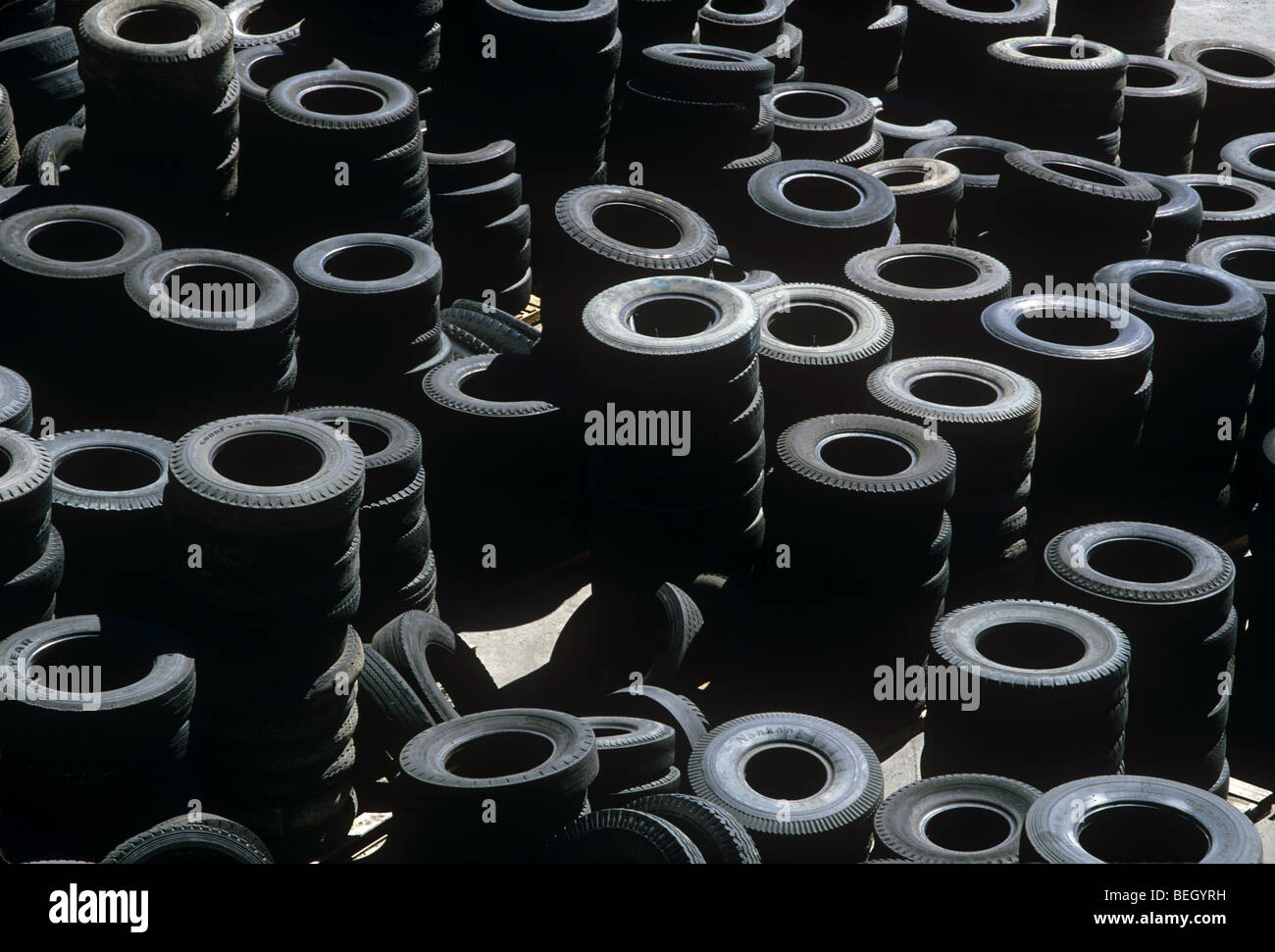 Piles of used tires at recycling plant Stock Photo - Alamy