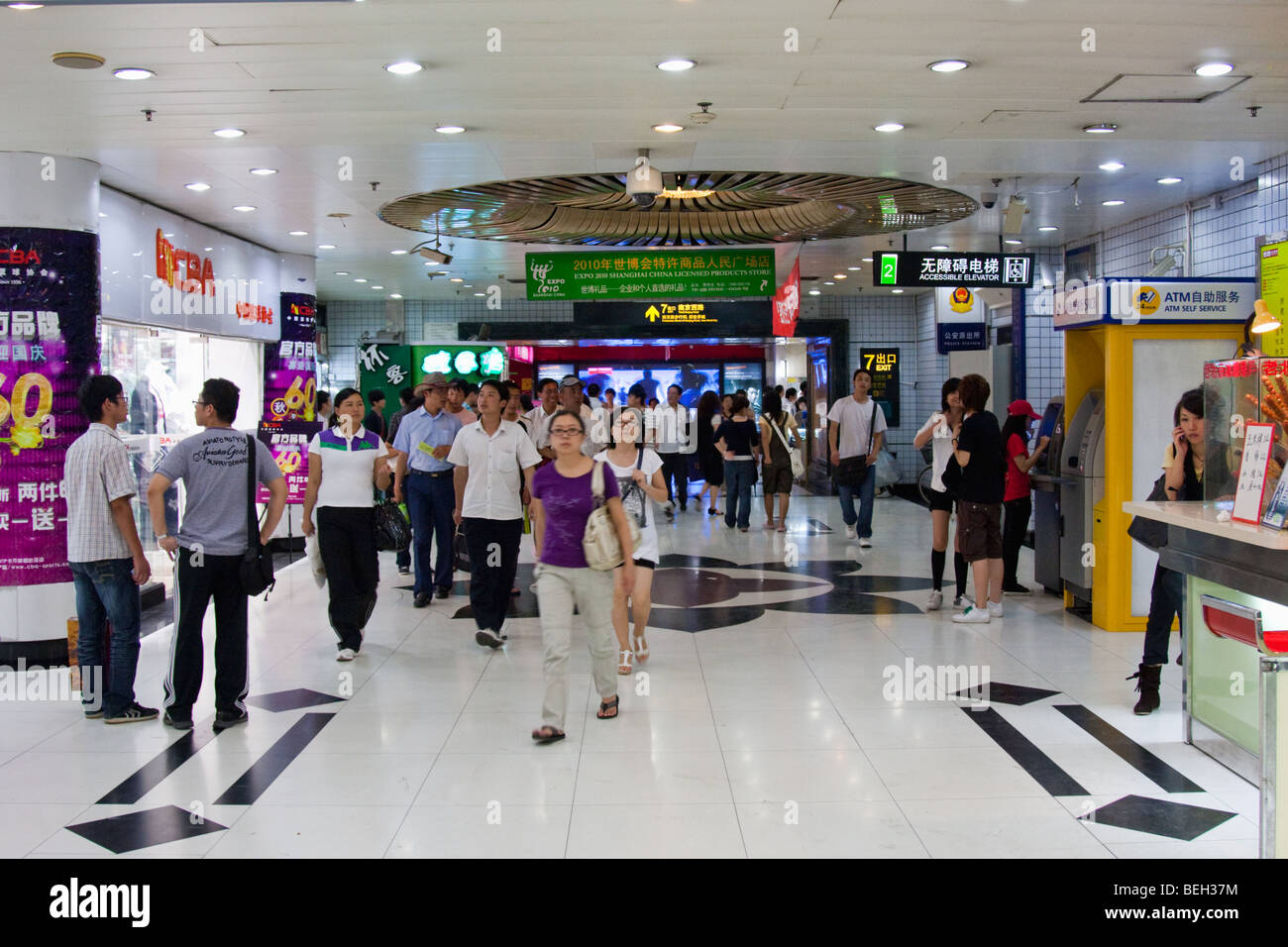 Poeple walking around shops inside a metro station in Shanghai China ...