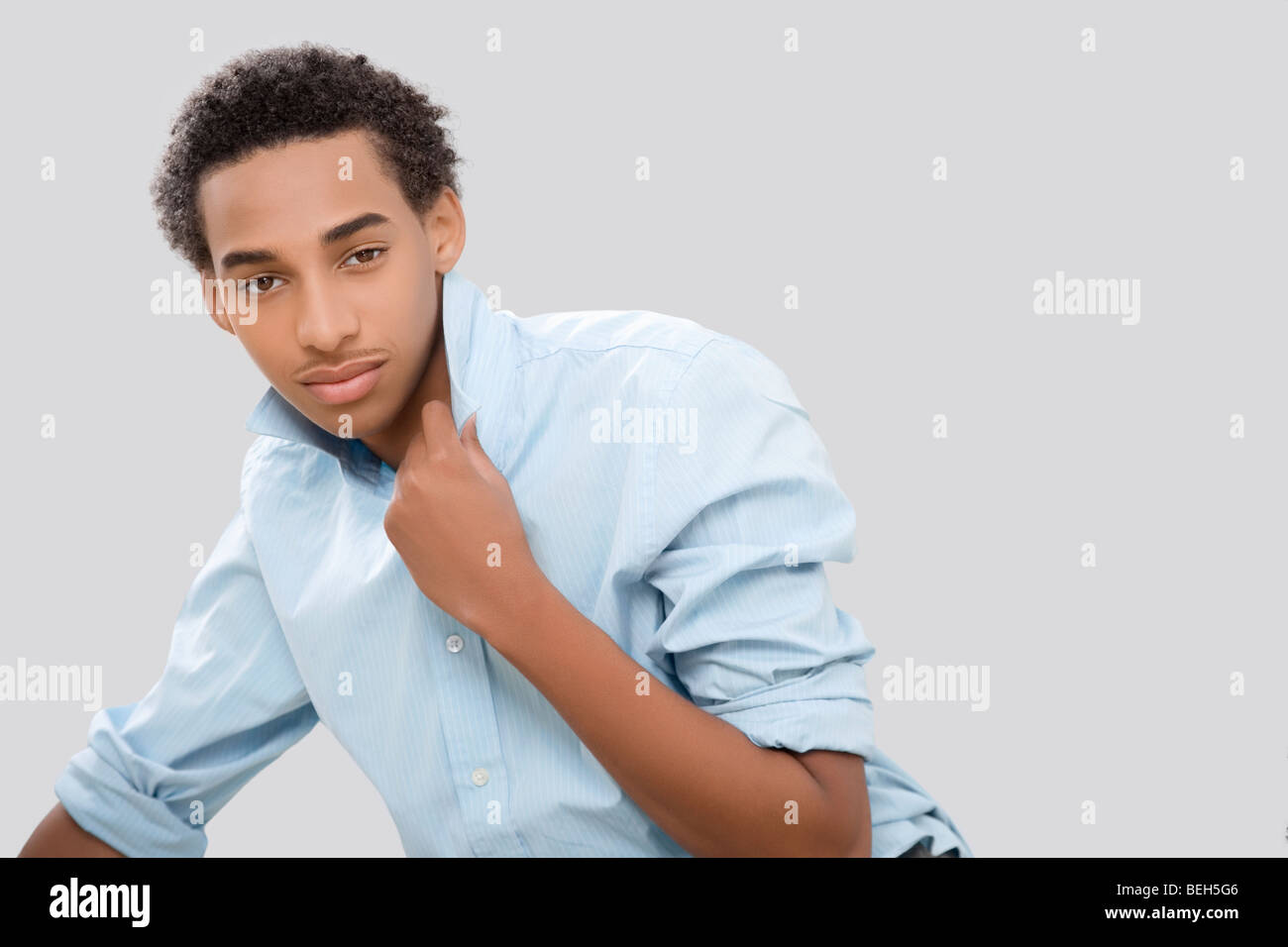 Young man adjusting his shirt's collar Stock Photo - Alamy