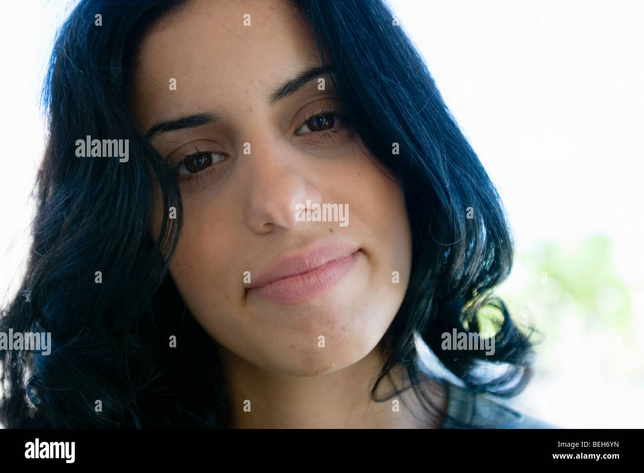 Portrait of a young woman smirking Stock Photo - Alamy