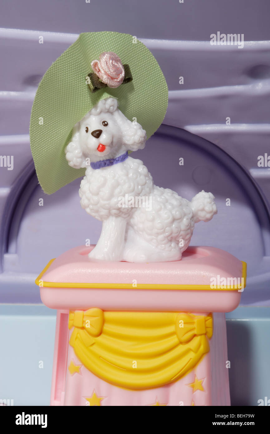 plastic dolls house poodle dog in a floppy hat Stock Photo - Alamy