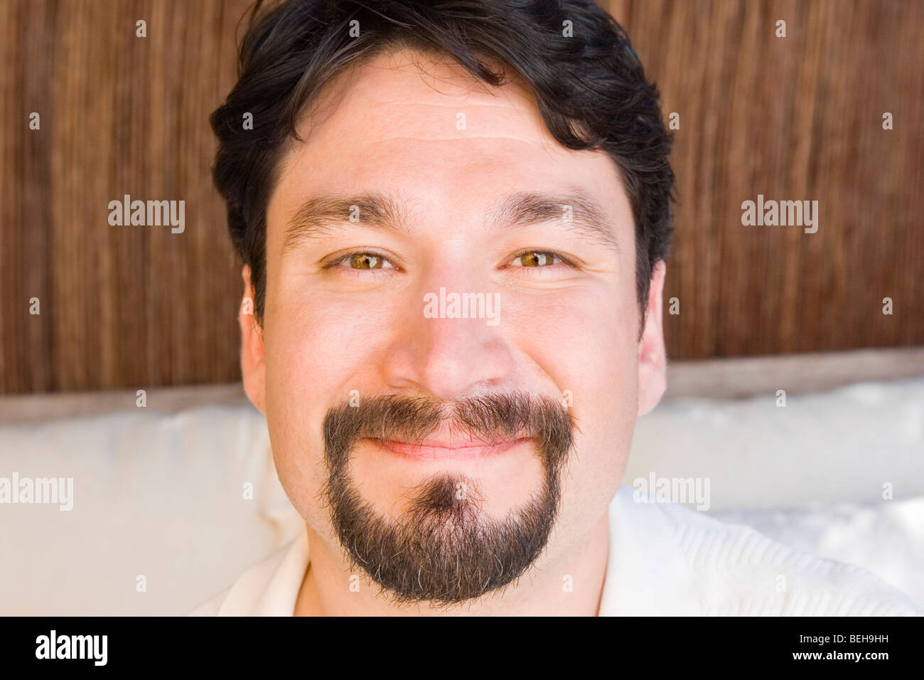 Portrait of a mid adult man smirking Stock Photo - Alamy