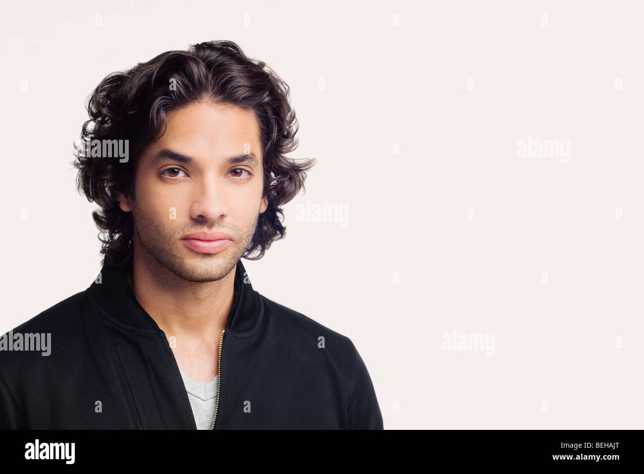 Portrait of a young man thinking Stock Photo - Alamy