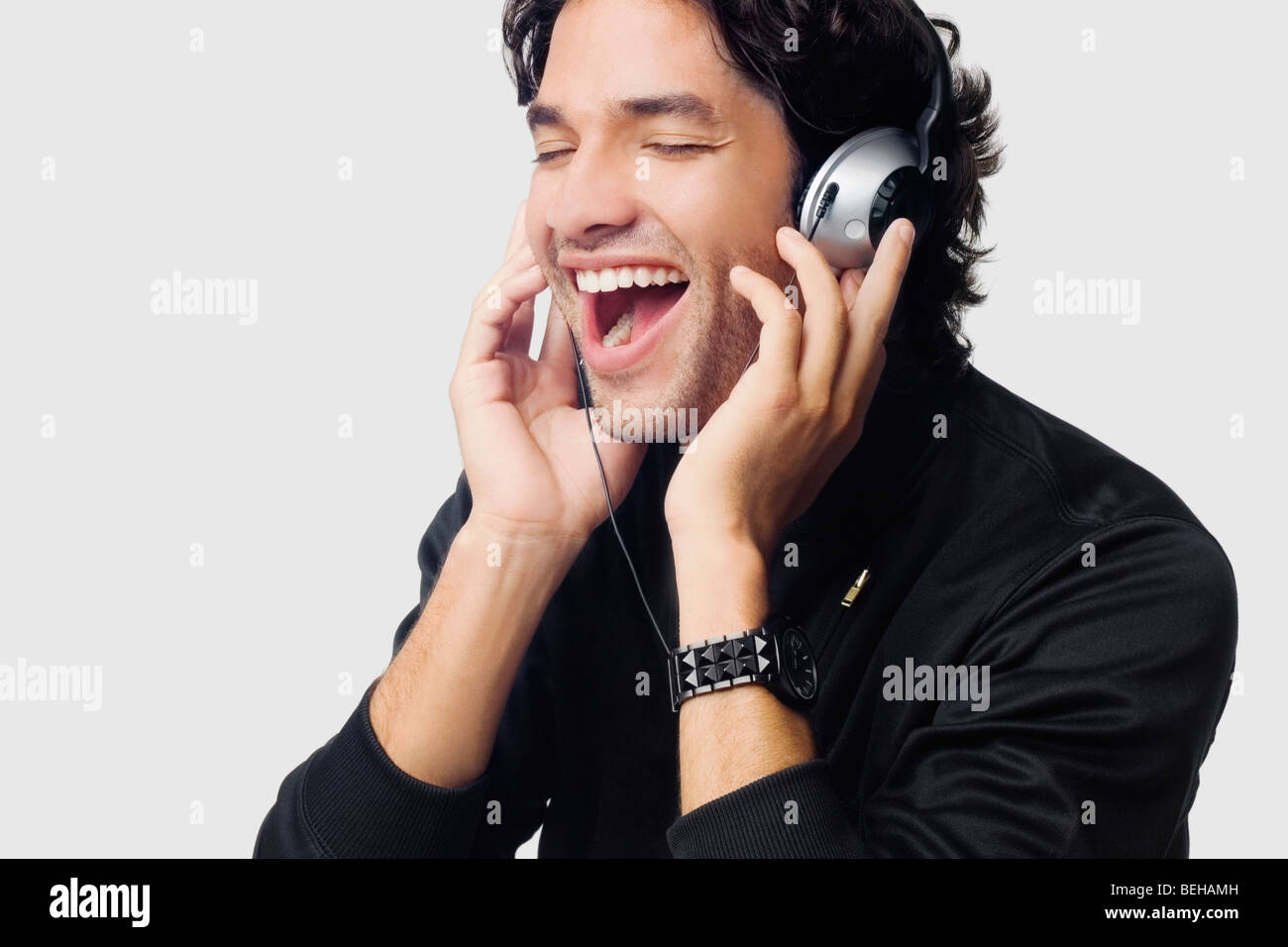 Close-up of a young man listening to music and laughing Stock Photo - Alamy