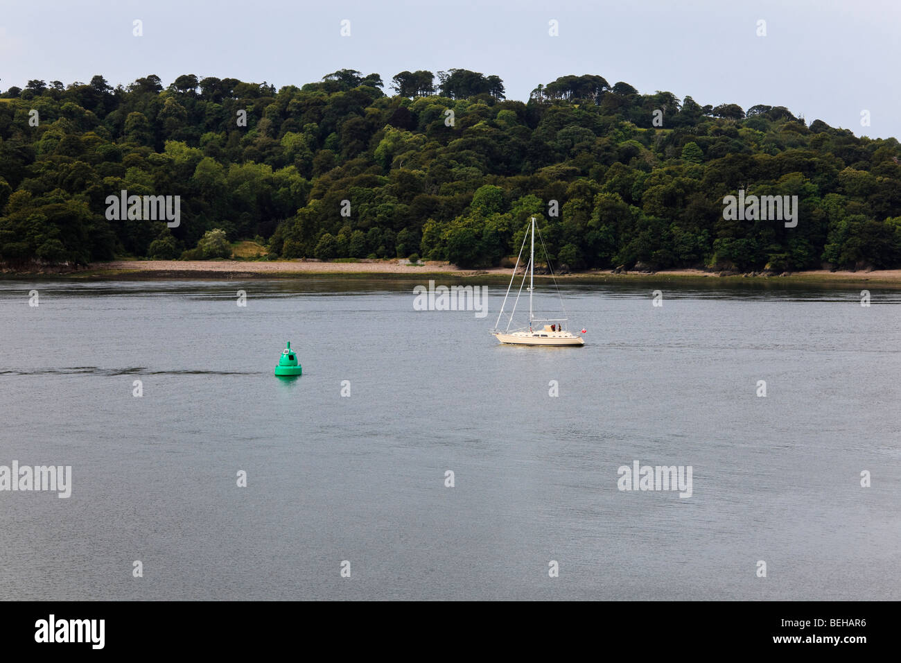 A Yacht leaves Plymouth, passing Devil's Point, Devon, UK Stock Photo ...