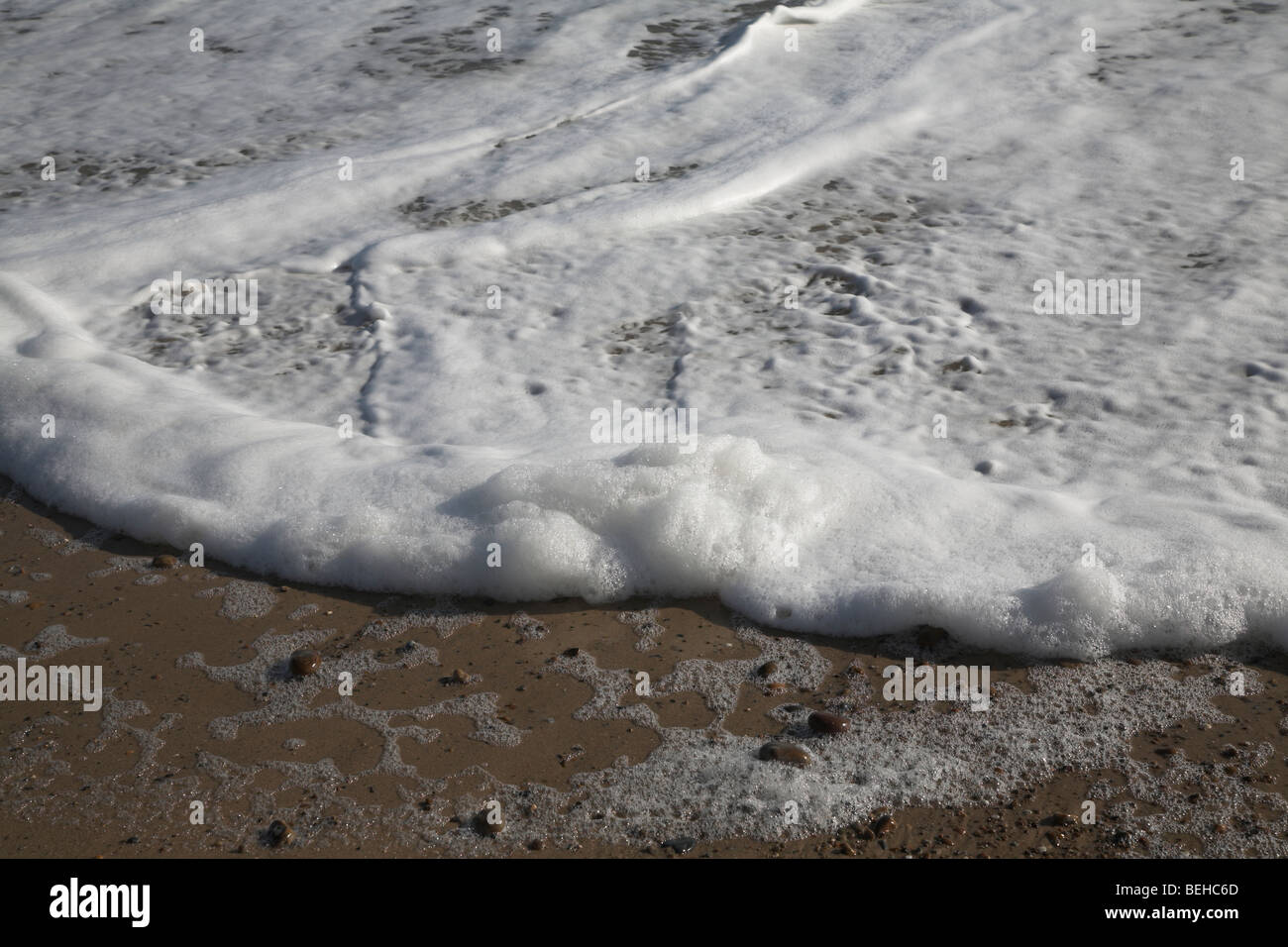 Backwash of wave on beach. Dunwich beach and cliffs, North Sea coast ...