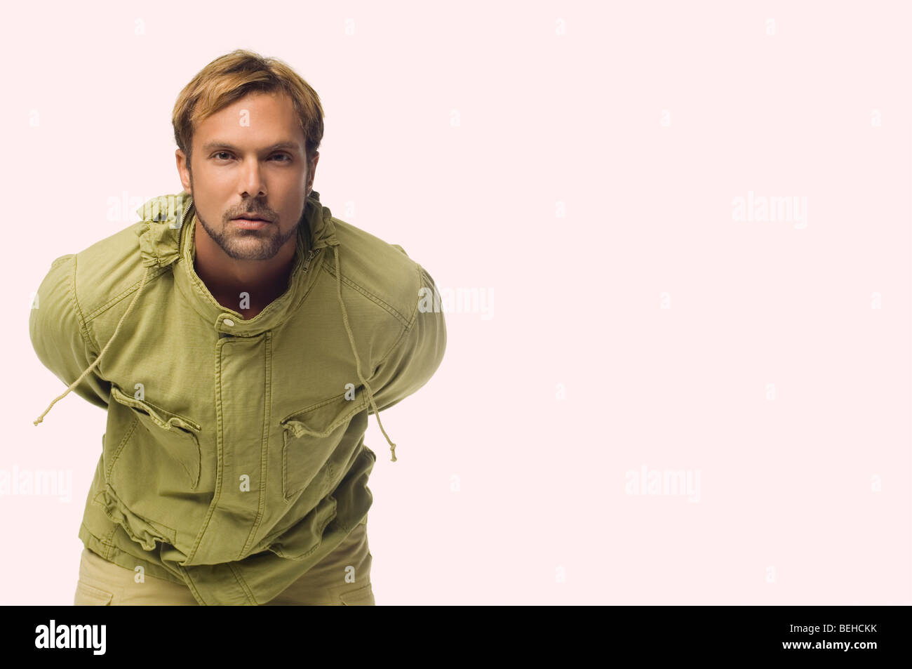 Portrait of a mid adult man bending forward Stock Photo - Alamy