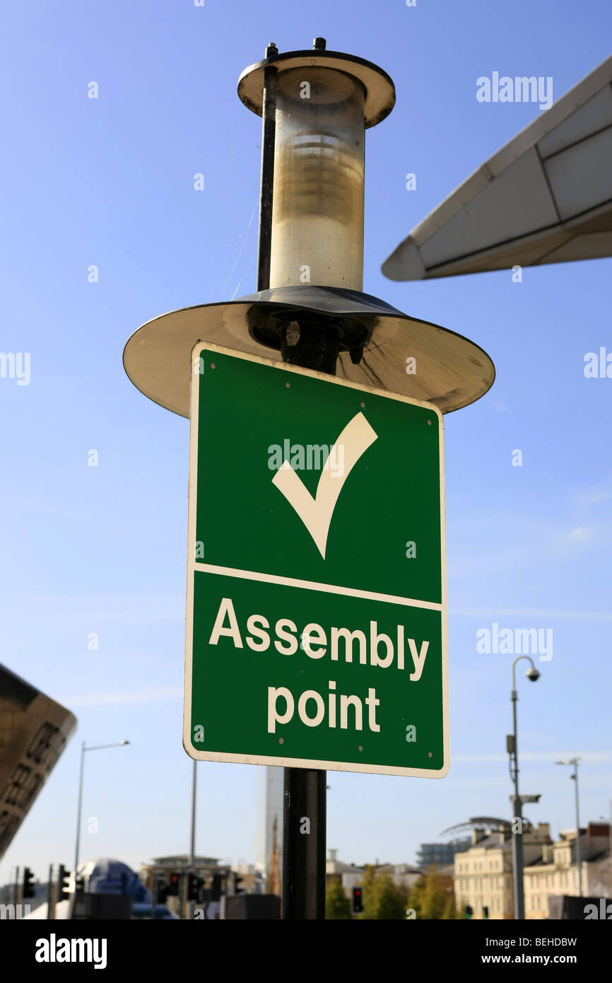 Big Green and white Assembly Point sign with a Tick Stock Photo - Alamy
