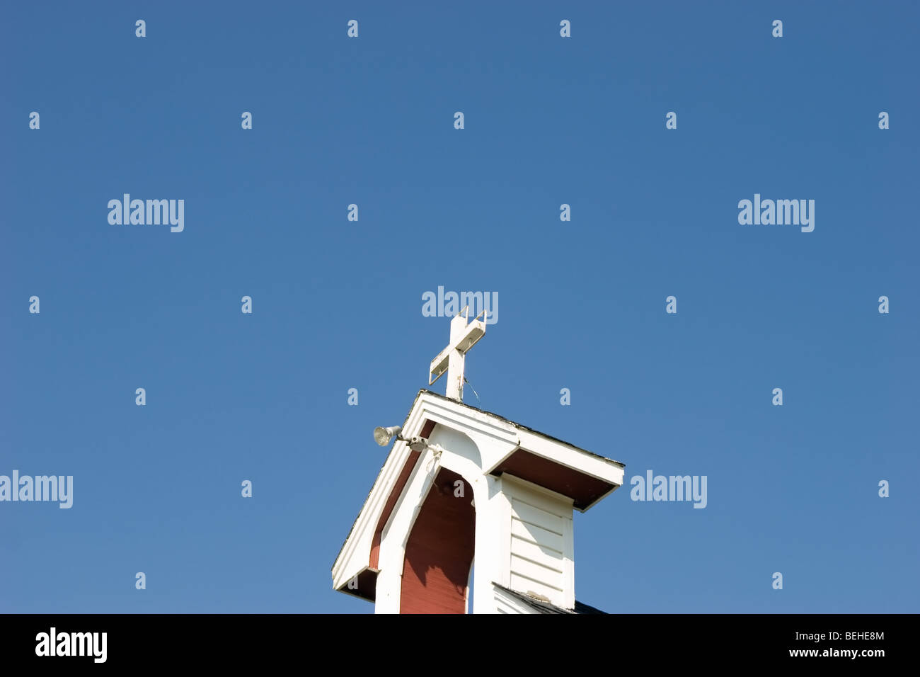 red and white church steeple with blue sky background Stock Photo - Alamy