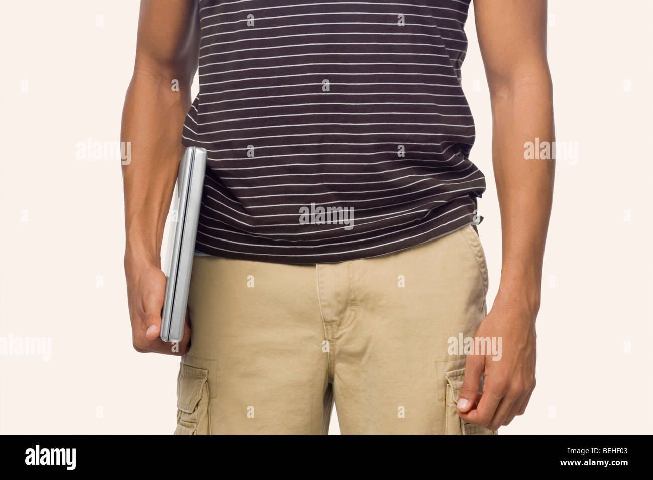 Mid section view of a mid adult man holding a laptop Stock Photo - Alamy
