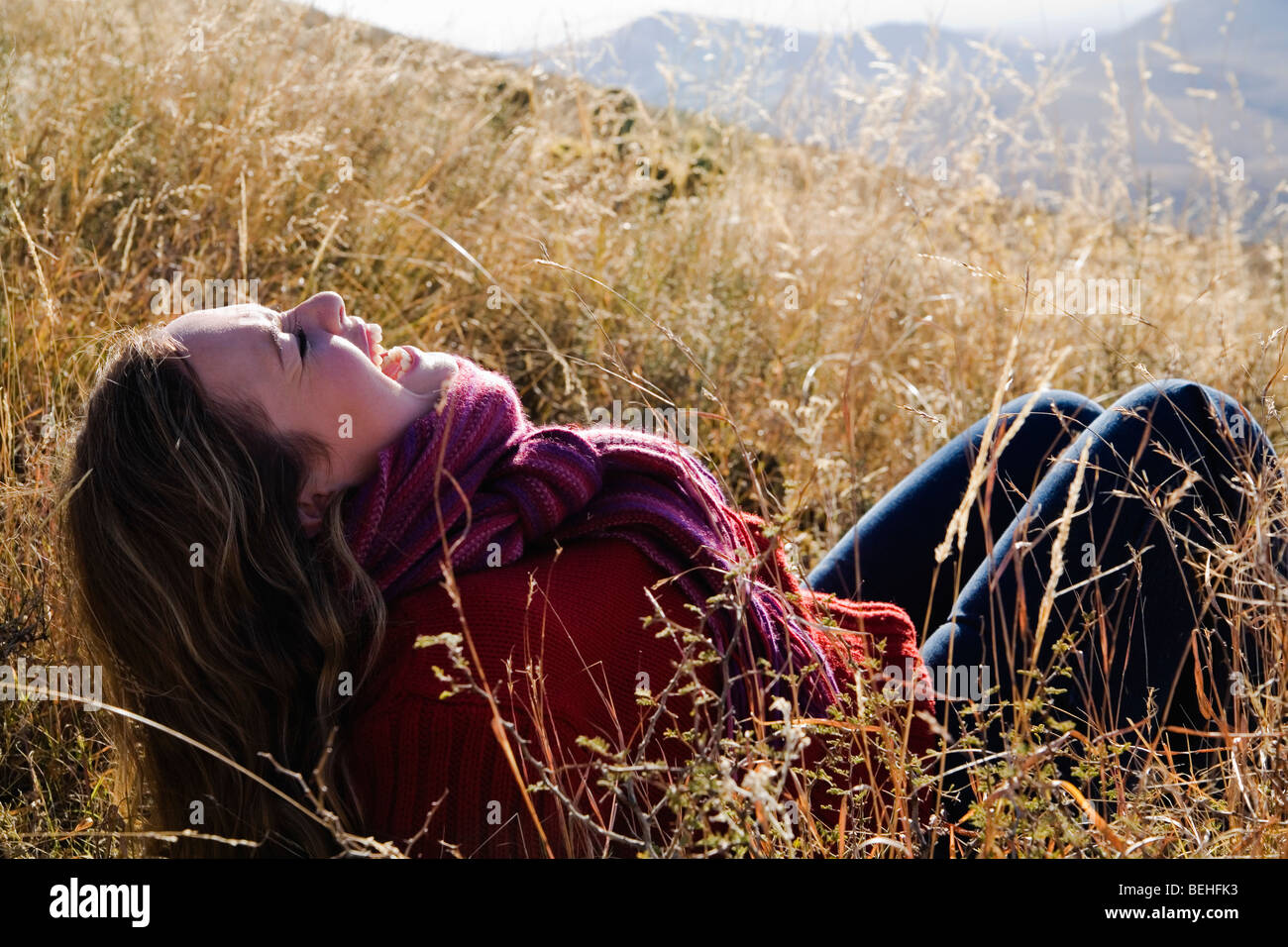 Side profile of a young woman laughing Stock Photo - Alamy