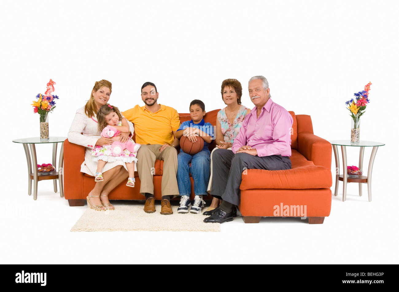 Portrait of a family sitting on couches and smiling Stock Photo - Alamy
