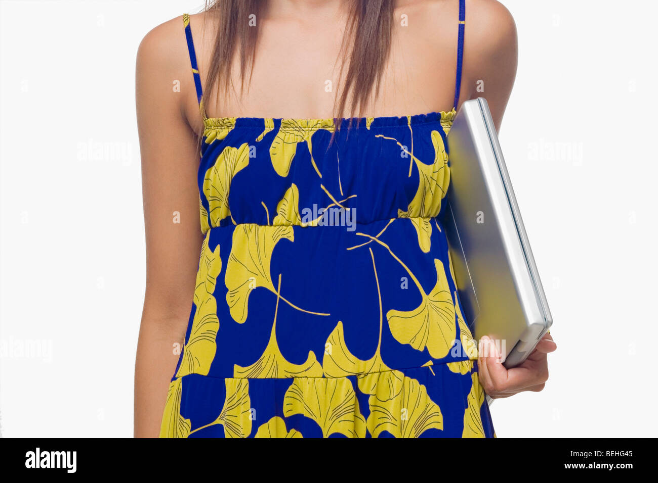 Mid section view of a young woman holding a laptop Stock Photo - Alamy