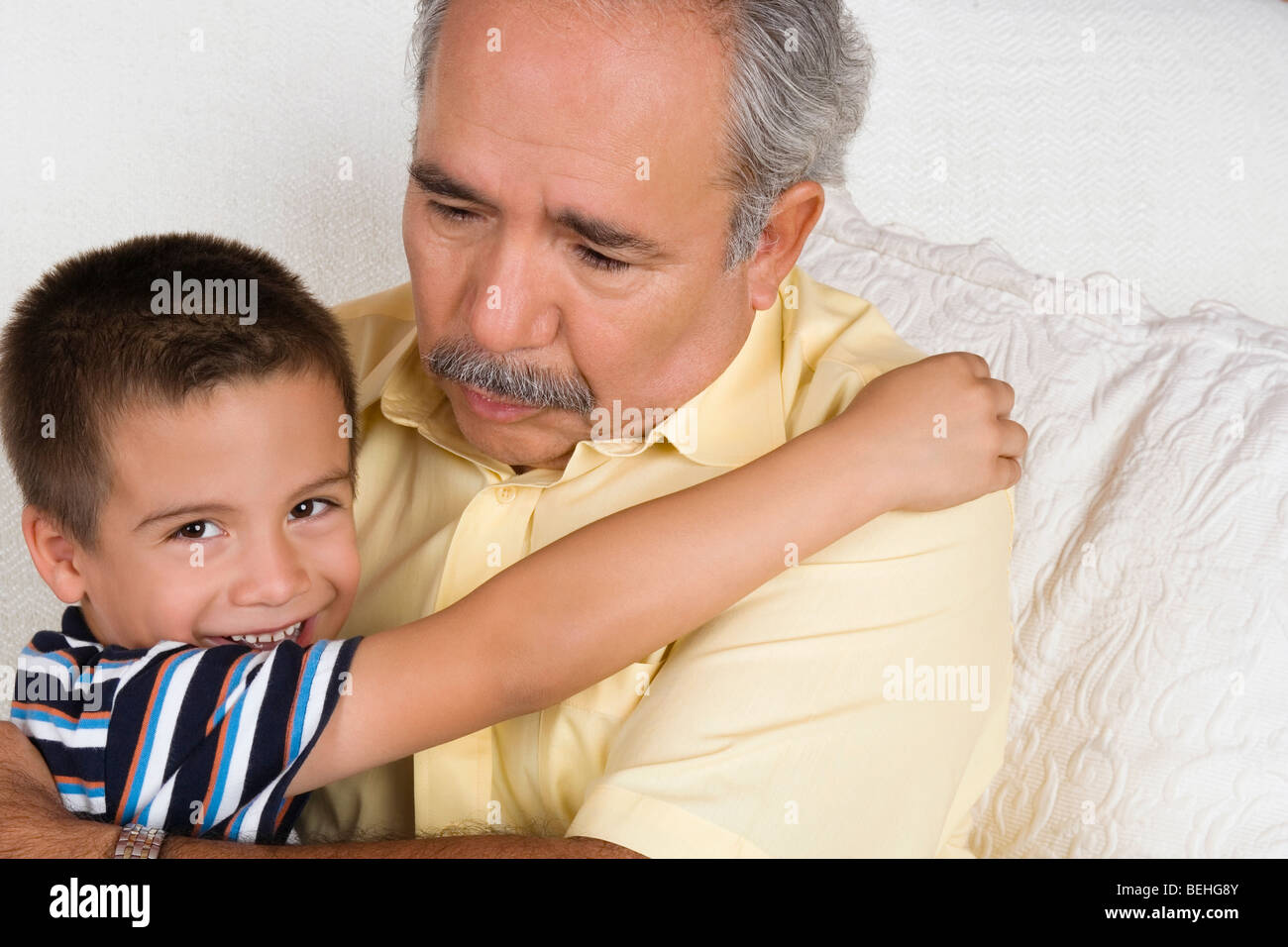 Portrait of a boy hugging his grandfather Stock Photo - Alamy