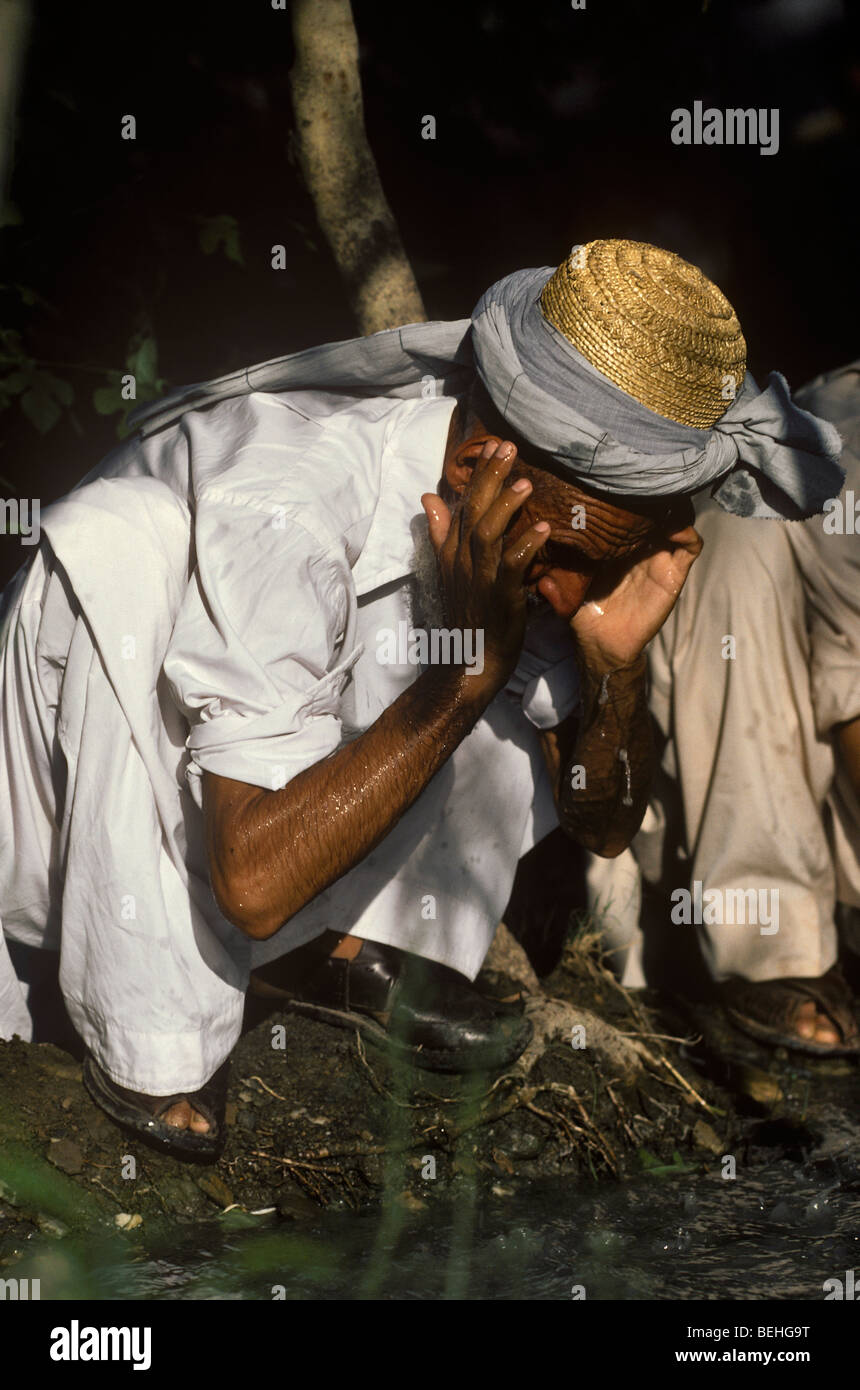 Pathan men washing before prayers at open-air mosque, Kado, Northwest ...