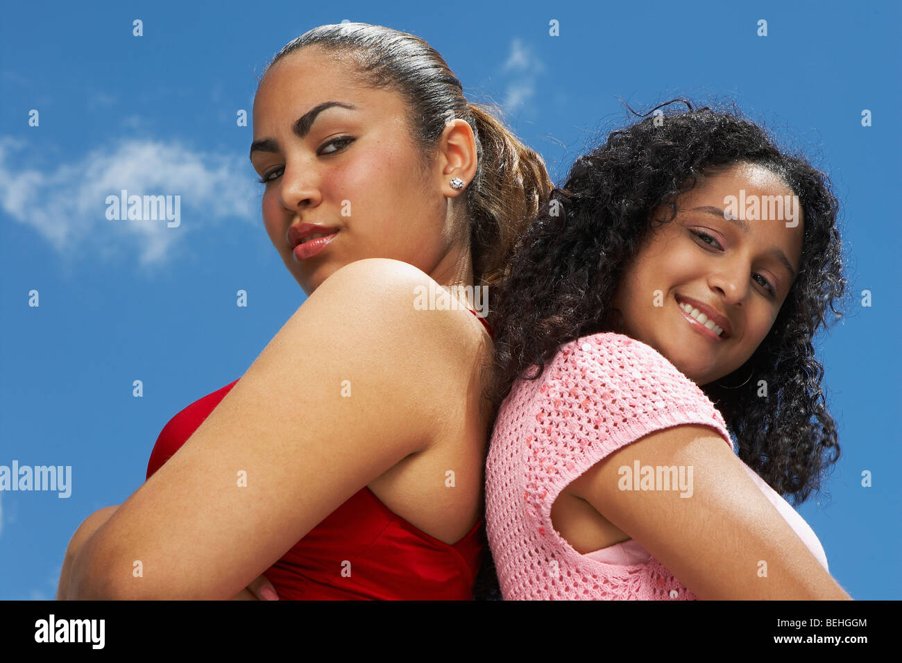 Side profile of two teenage girls standing back to back Stock Photo - Alamy