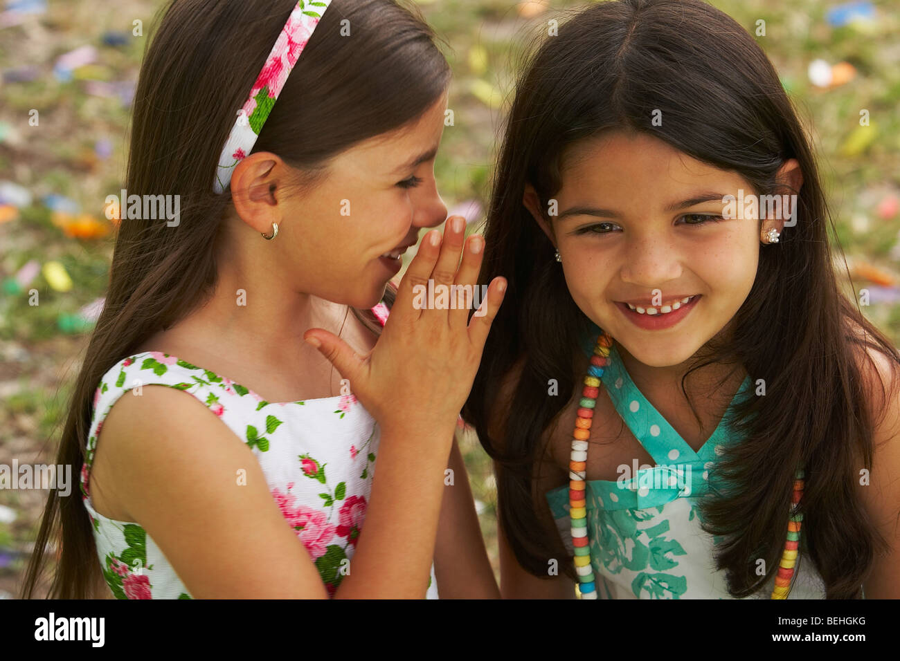 Close-up of a girl whispering to another girl Stock Photo - Alamy
