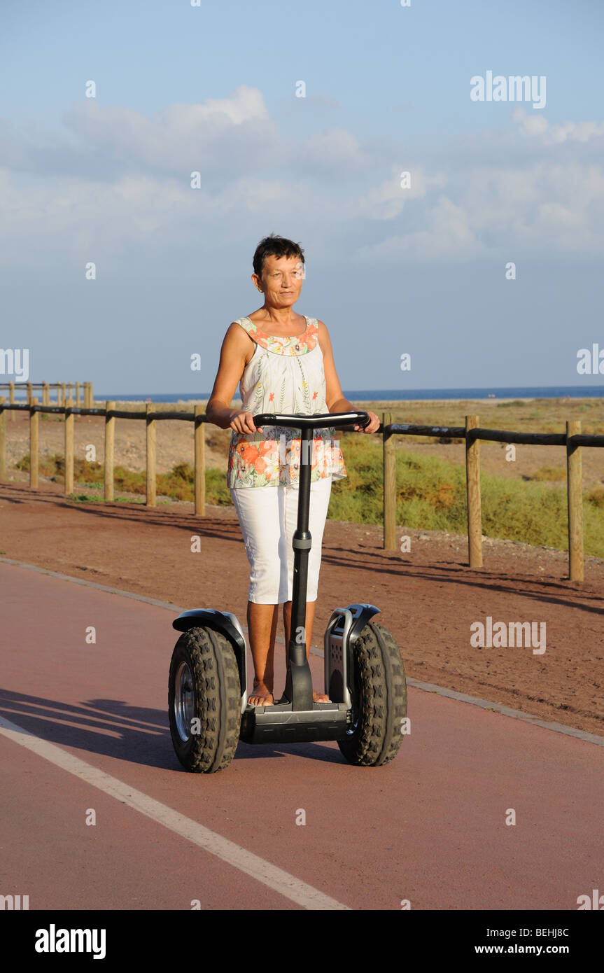Pensioner woman driving segway Stock Photo - Alamy